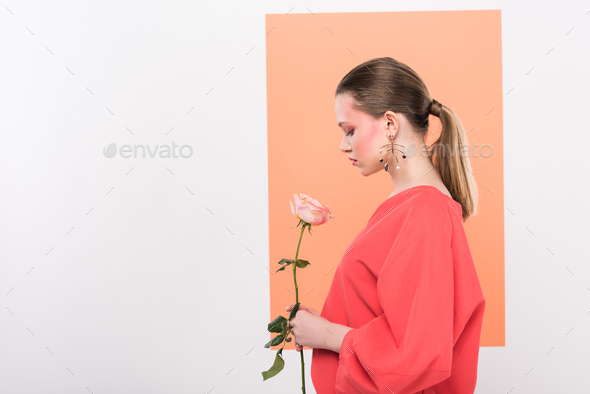 beautiful fashionable girl holding rose and posing with living coral on ...