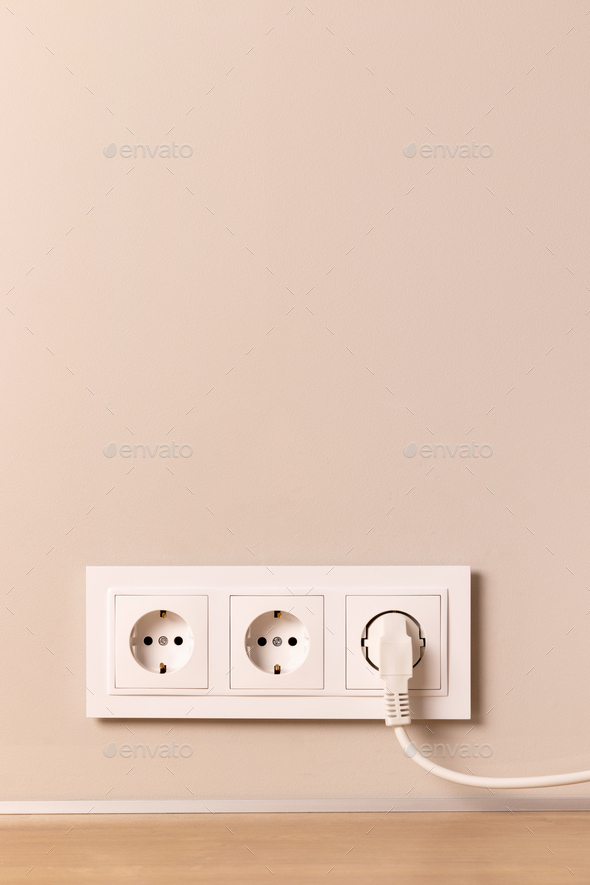 Electrical outlets with plug on beige wall Stock Photo by Bykfa | PhotoDune
