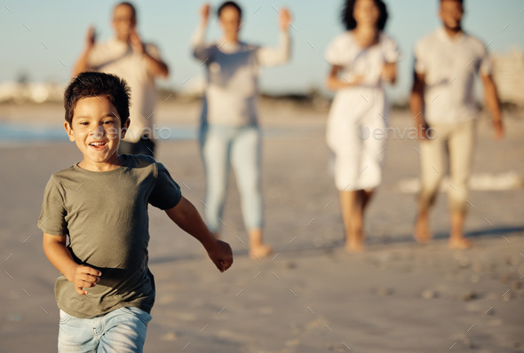 Boy running on beach with family clapping hands and cheer while walking ...