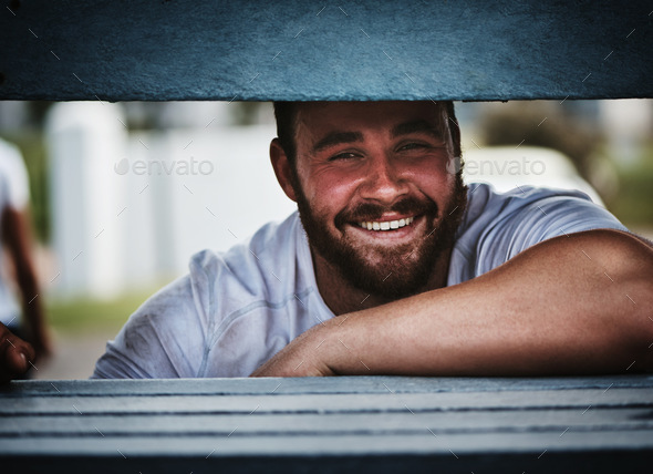 Cropped portrait of a handsome young rugby player smiling while sitting ...
