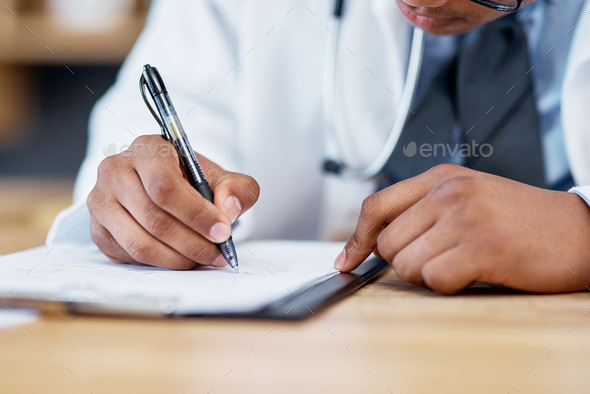 Closeup shot of an unrecognisable doctor writing notes on a clipboard ...