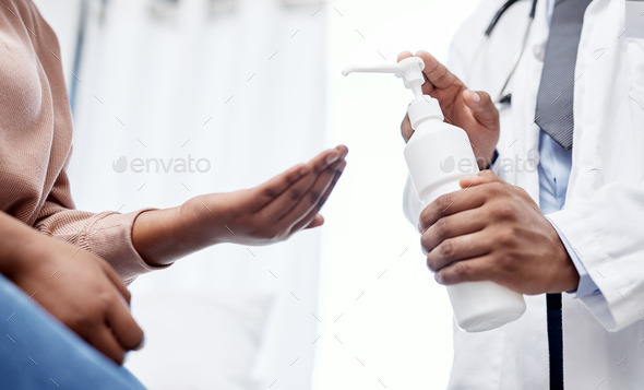 Closeup shot of an unrecognisable doctor giving hand sanitiser to a ...