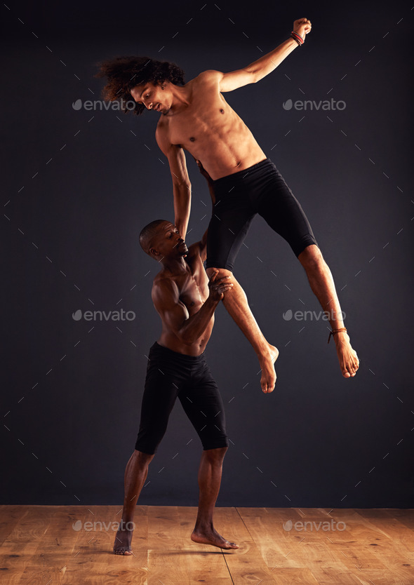 Two male contemporary dancers performing a dramatic pose in front of a ...