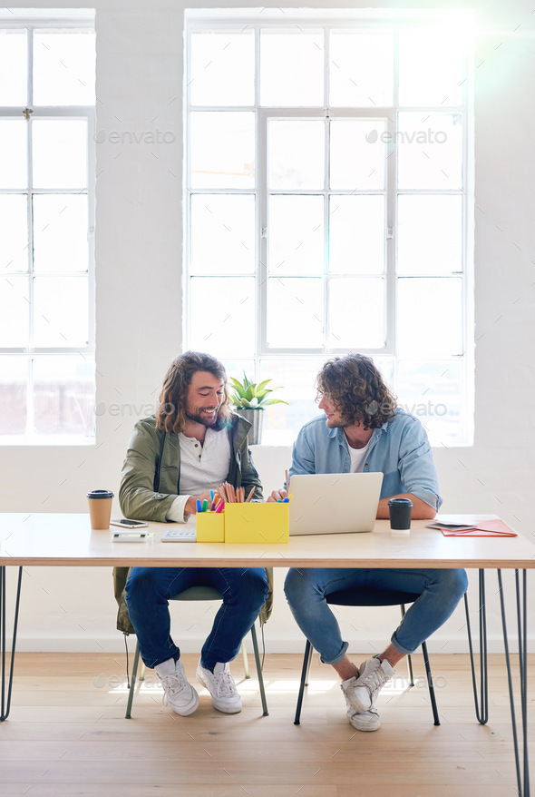 College students working together two young men brainstorming ideas for ...