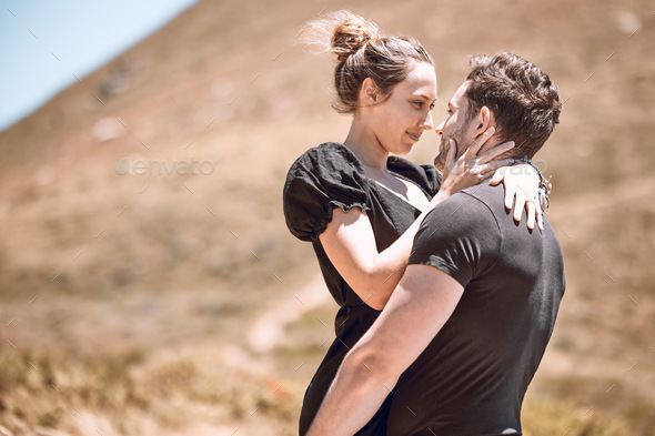 Carefree, relaxed and romantic couple bonding, hugging and giving ...