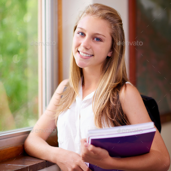 School is awesome. Shot of a young girl in her school hallway. Stock ...