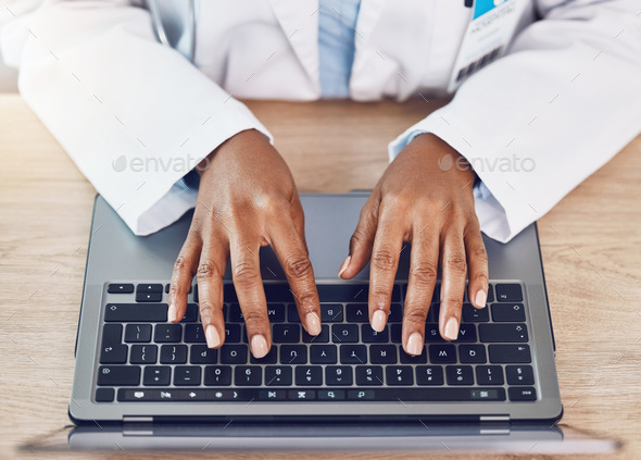 Above closeup african american woman doctor using a laptop computer ...