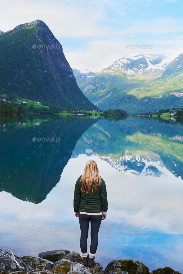 Adventure woman enjoying view of majestic mountain lake explore travel discover beautiful earth ...