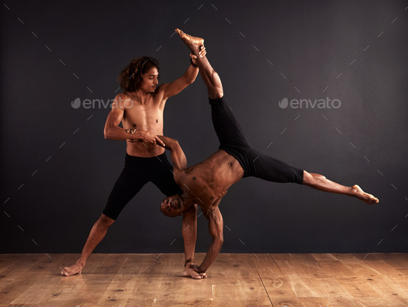 Two male contemporary dancers performing a dramatic pose in front of a ...