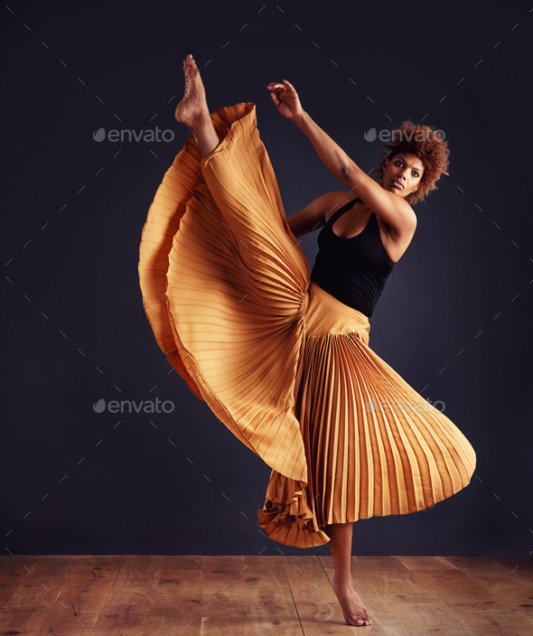 Dedication to expression. Female contemporary dancer in a dramatic pose ...