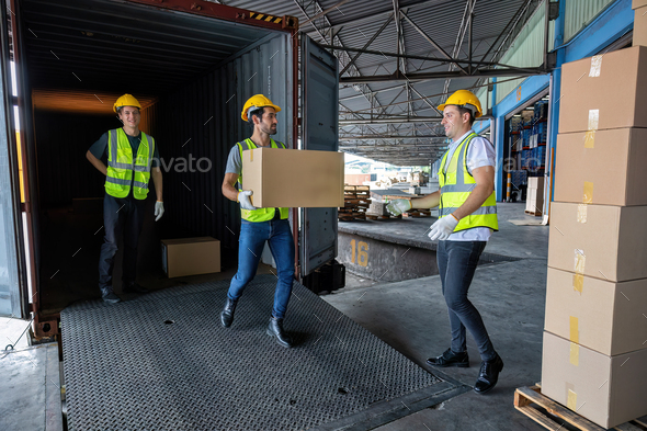 Worker carry carton box taken from 40 feet steel container on the ...