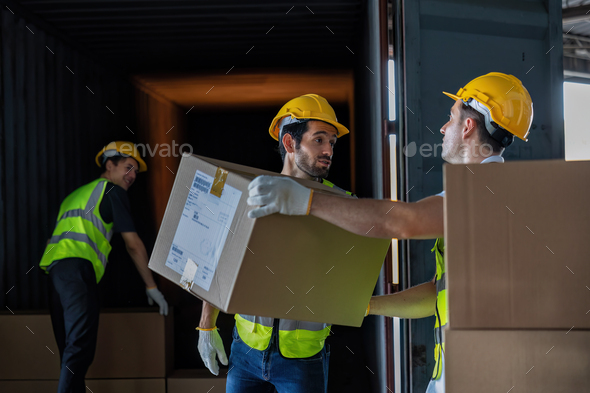 Worker carry carton box taken from 40 feet steel container on the ...