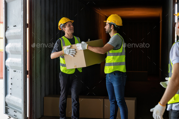 Worker carry carton box taken from 40 feet steel container on the ...
