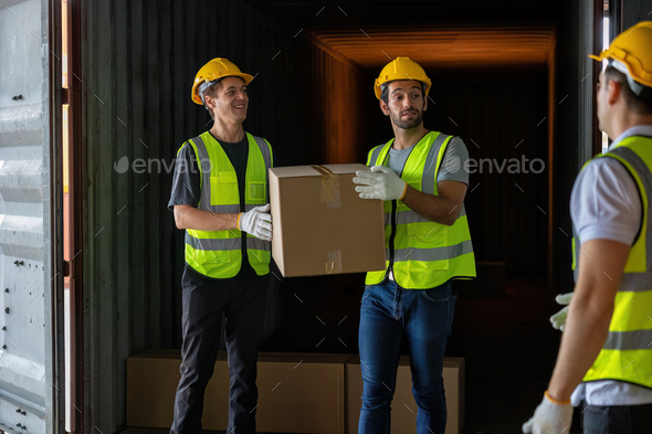 Worker carry carton box taken from 40 feet steel container on the ...