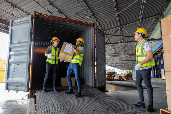 Worker carry carton box taken from 40 feet steel container on the ...