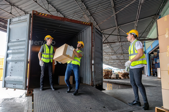 Worker carry carton box taken from 40 feet steel container on the ...