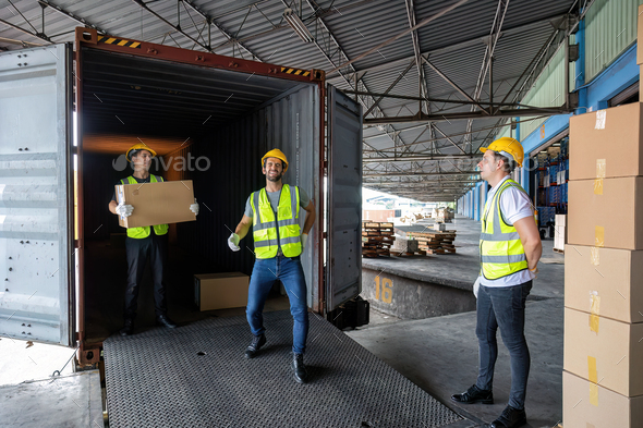 Worker carry carton box taken from 40 feet steel container on the ...