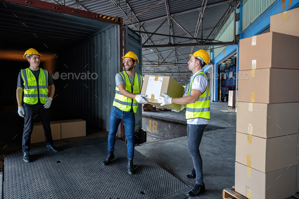 Worker carry carton box taken from 40 feet steel container on the ...