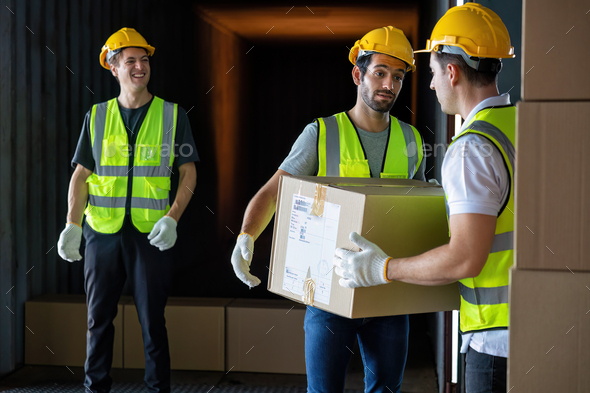 Worker carry carton box taken from 40 feet steel container on the ...