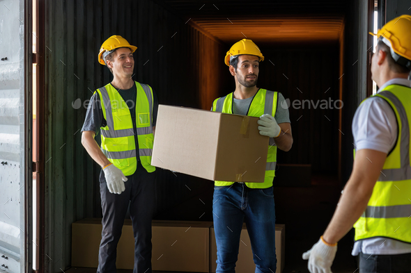 Worker carry carton box taken from 40 feet steel container on the ...
