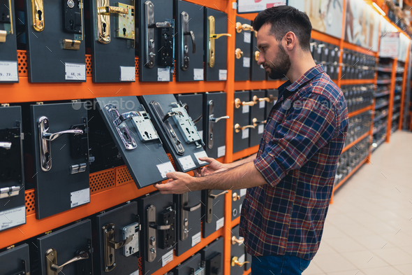 construction shop shopper next to rack with doorknobs and locks Stock ...