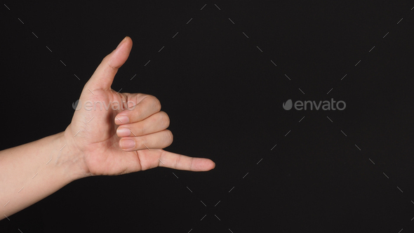Call me hand sign or gesture on black background. Stock Photo by puibunny