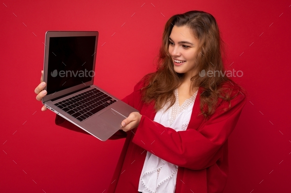 Photo of Beautiful smiling happy young brunette woman holding computer ...