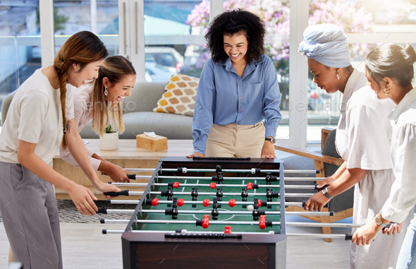 Table football, soccer or foosball as women play a fun game together ...