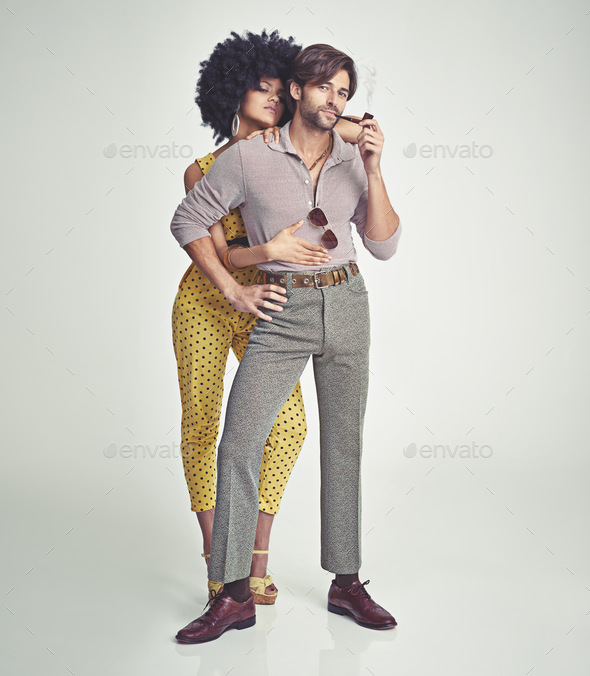 Retro couple. An attractive young couple standing together in retro 70s ...
