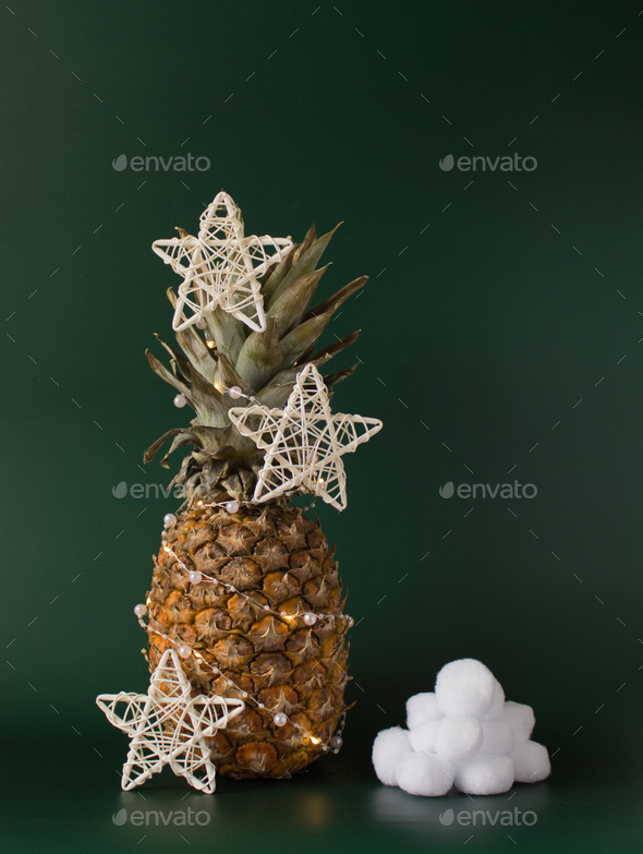 Christmas decor concept with pineapple, white wicker stars and ...