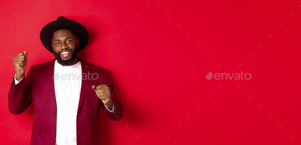 Fashion and party concept. Handsome Black man celebrating in jacket and ...