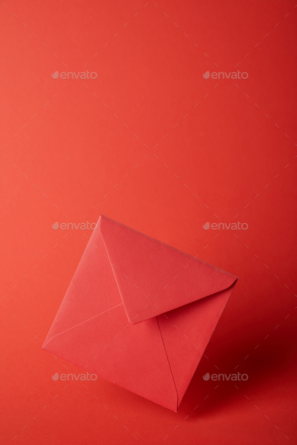bright, colorful and empty envelope on red background with copy space ...