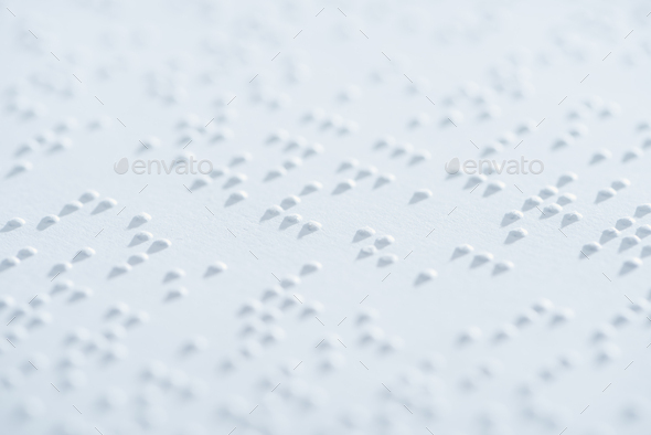 close up view of text in international braille code on white paper ...