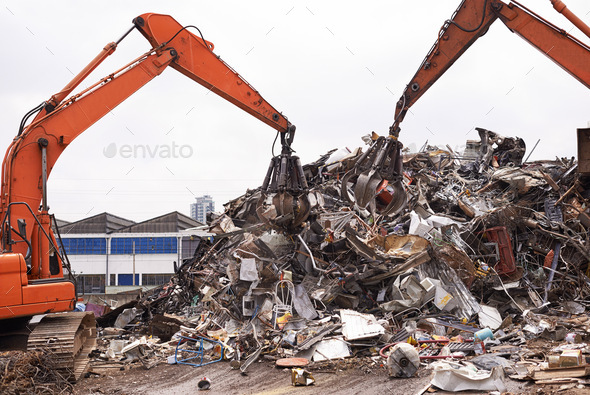 Industrial re-purposing. Cropped shot of two excavators sorting through ...