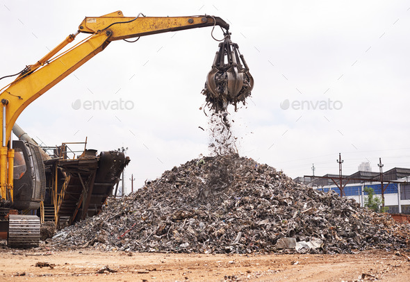 Industrial re-purposing. Cropped shot of an excavator sorting through a ...