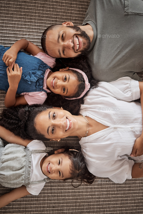 Portrait of family face lying on the floor together and being ...