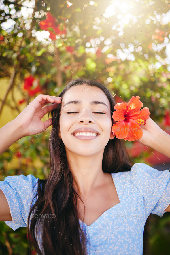 Girl, tropical flower and garden in summer sunshine on vacation ...