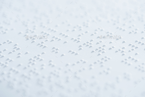 close up view of text in international braille code on white paper ...