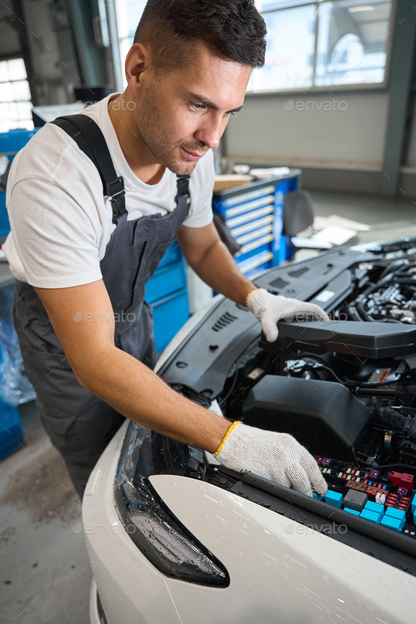 Close up photo of mechanic checking parts of automobile Stock Photo by ...