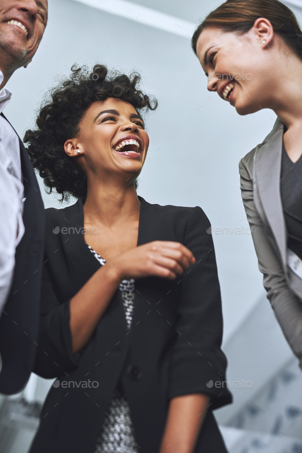 Shot of colleagues laughing together in an office Stock Photo by ...