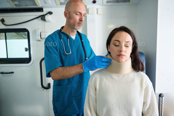 Medical worker checks the fastening of brace on the neck Stock Photo by ...