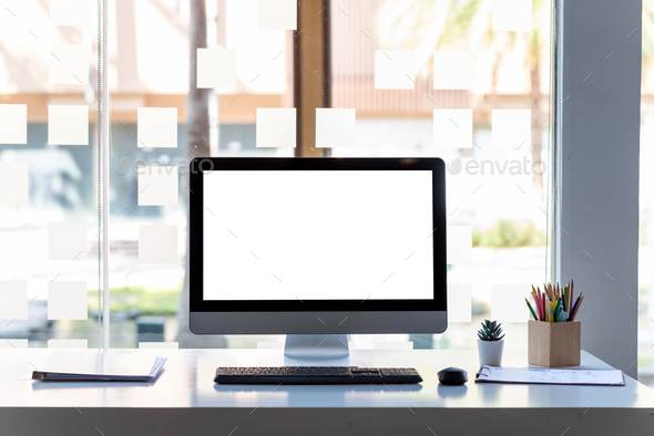Computer white screen with a keyboard placed at the office. Mock up ...