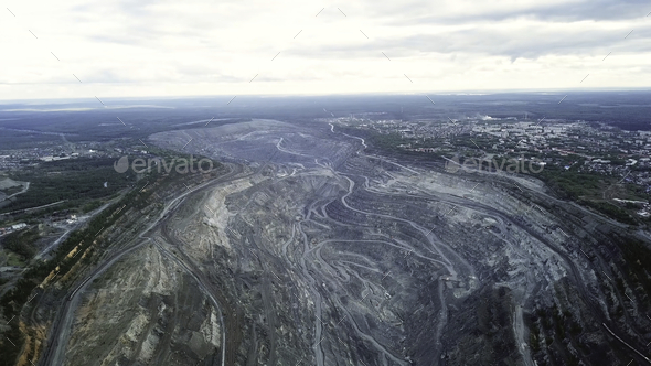 Coal mining at an open pit. Top view of the quarry. Dozers and trucks ...
