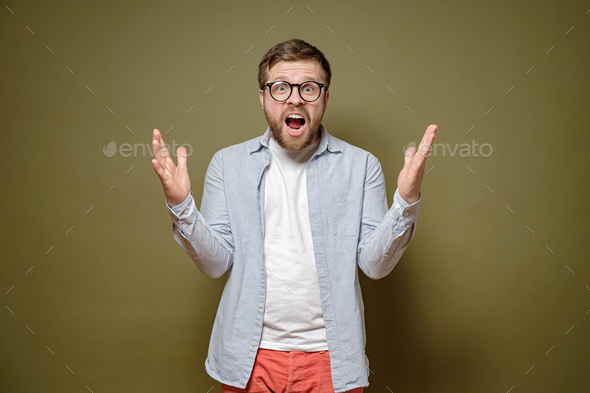 Caucasian man is pleasantly surprised and shocked by an unexpected ...