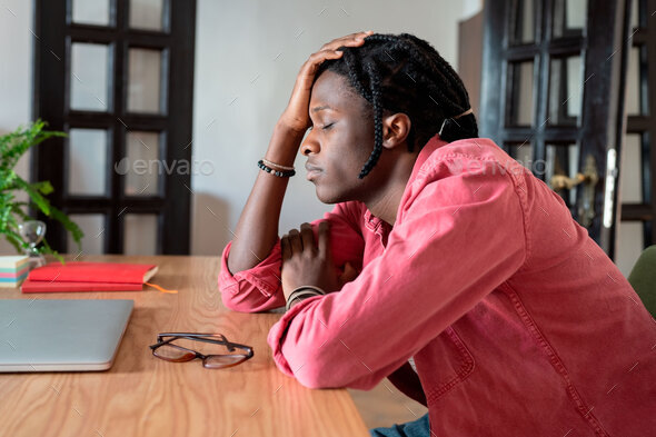 Exhausted overworked remote employee sitting with closed eyes at ...
