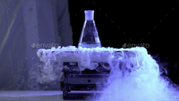 Bottle and liquid nitrogen in a laboratory. Chemical experiment. Flask ...