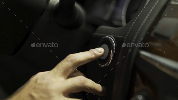 Close up for car driver starting the engine of the modern vehicle ...