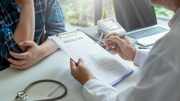 Doctor explain the prescription to the patient At the doctor's office ...