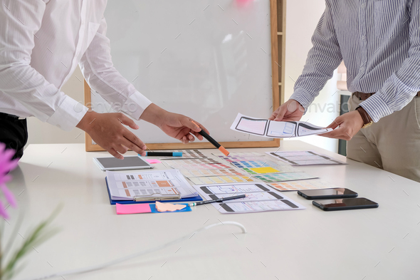 Designer meeting for work development Mobile phone at the office. ux ui ...