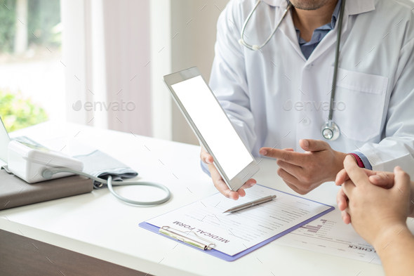 Doctor guides the patient through a blank screen tablet At the doctor's ...
